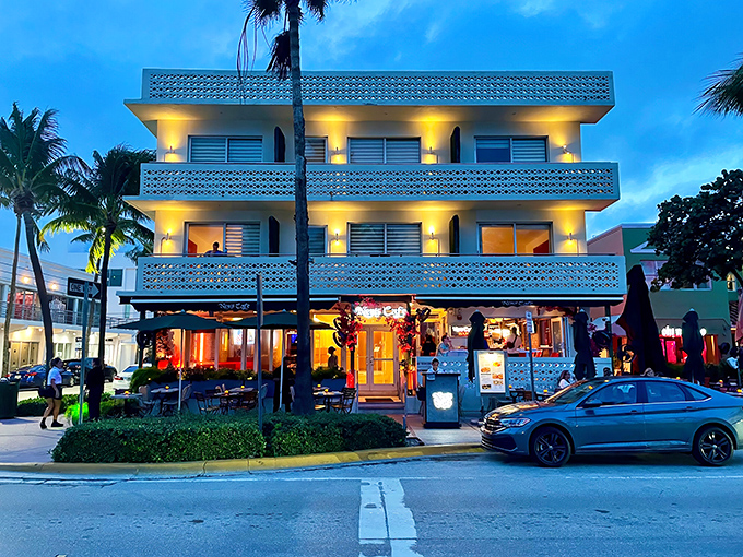 As day transitions to evening, News Cafe's warm glow beckons passersby like a lighthouse for the hungry and curious.