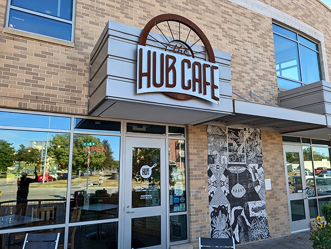 The Hub Cafe's distinctive wagon wheel logo welcomes hungry travelers like a beacon of breakfast hope in Lincoln's brick-lined Haymarket District.
