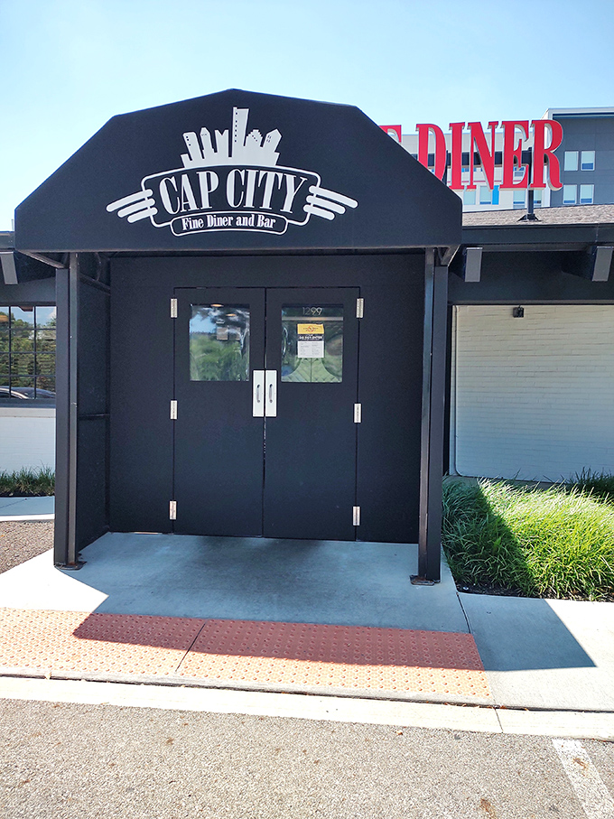 The bold red lettering of Cap City Fine Diner beckons like a neon promise of comfort food nirvana. Classic diner aesthetics with an upscale twist.