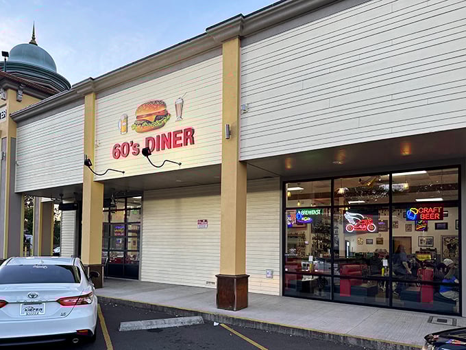 The iconic 60's Diner sign beckons hungry travelers like a neon-lit time machine. One glance and you're already tasting those legendary burgers.