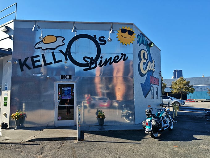 The shiny metallic exterior of Kelly O's Diner gleams in the sunlight, that giant sunny-side-up egg logo practically winking at hungry passersby.