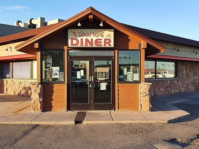 The rustic stone and timber exterior of Down Home Diner stands like a beacon of breakfast hope against the Wyoming sky. Morning salvation awaits inside.