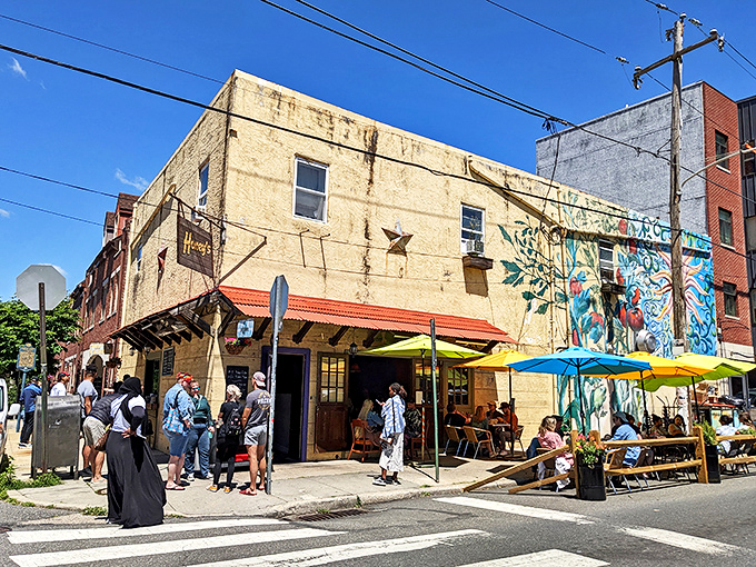 The corner spot that launched a thousand brunch dreams. Honey's weathered exterior and vibrant umbrellas promise culinary magic within.