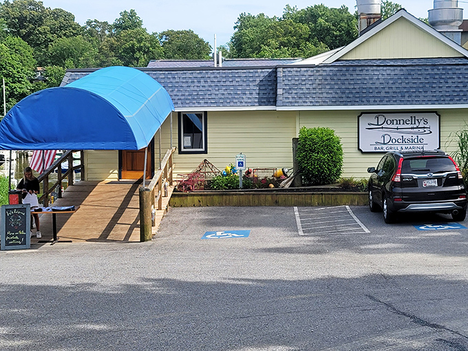 That cheerful blue umbrella marking the entrance is basically a lighthouse guiding you to crab cake paradise.