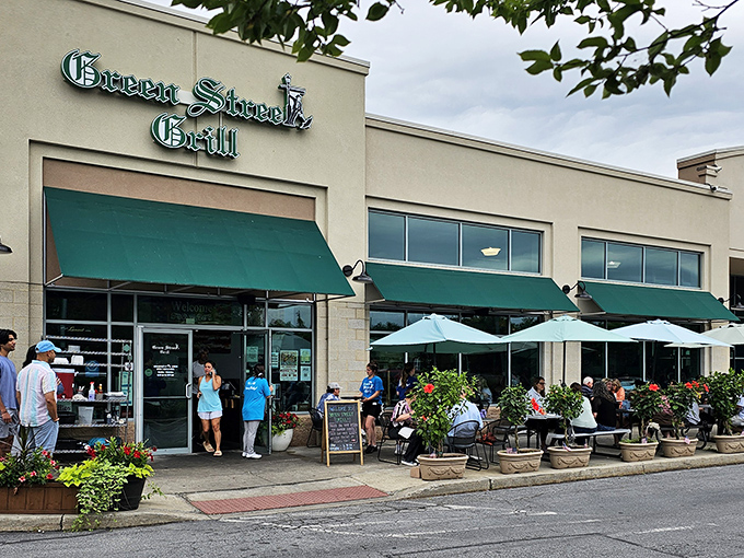 The sunny exterior of Green Street Grill beckons with its distinctive green awnings and colorful flower arrangements. A hidden gem worth the drive to Downingtown.