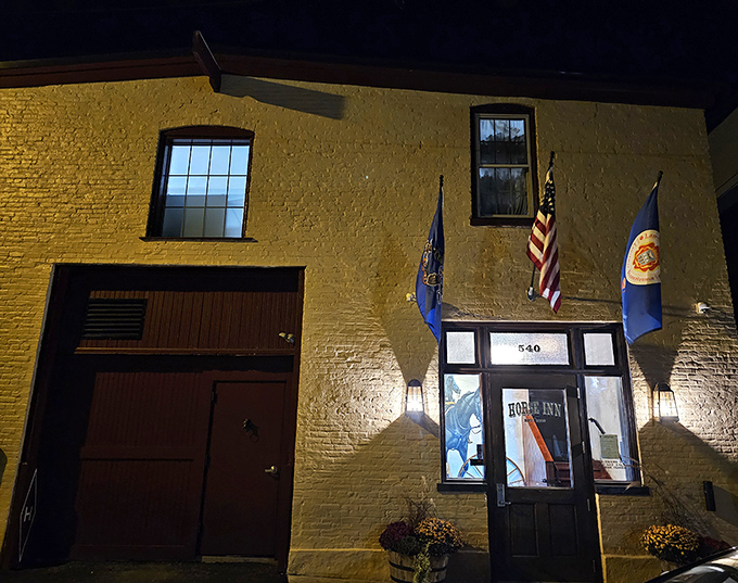 Flags flutter above the historic speakeasy-turned-restaurant, where the exterior's humble charm belies the extraordinary flavors waiting inside this Lancaster treasure.