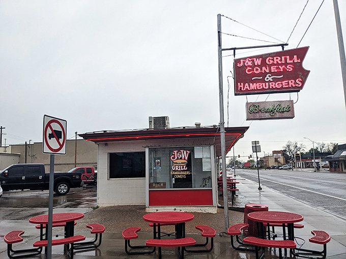 The iconic red and white exterior of J&W Grill stands as a time capsule of Americana, beckoning hungry travelers with its vintage neon promise of burgers and coneys.