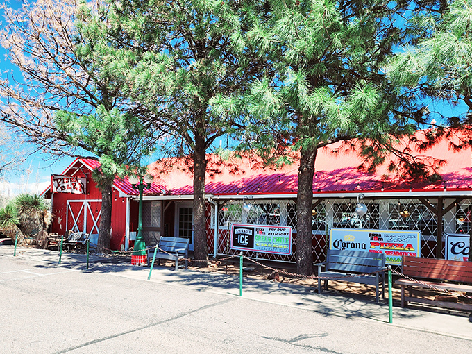 The iconic red barn exterior stands like a pizza oasis in Edgewood, where pine trees provide shade for hungry travelers seeking refuge.