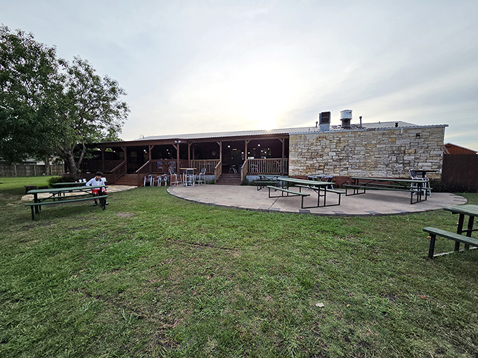The rustic stone exterior of Good Luck Grill welcomes hungry travelers with its wide porch and promise of Texas-sized comfort food waiting inside.