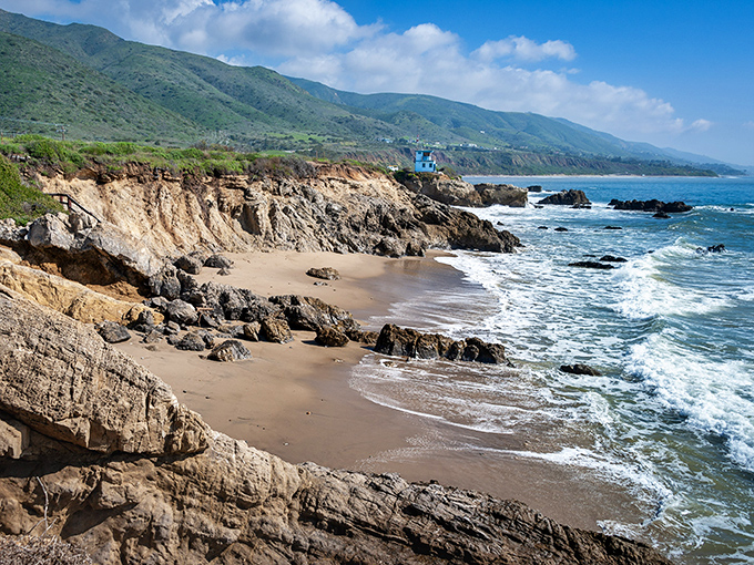 Mother Nature's masterpiece unfolds at Leo Carrillo, where rugged cliffs meet gentle waves. The iconic blue lifeguard tower stands sentinel over this slice of Malibu paradise.