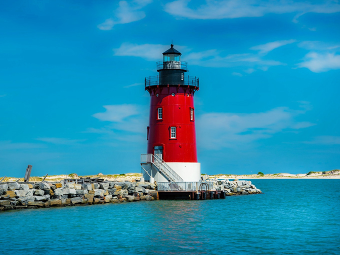 Standing proud like a crimson sentinel against the azure Delaware Bay, this lighthouse doesn't just guide ships&mdash;it beckons adventurous souls from miles around. 