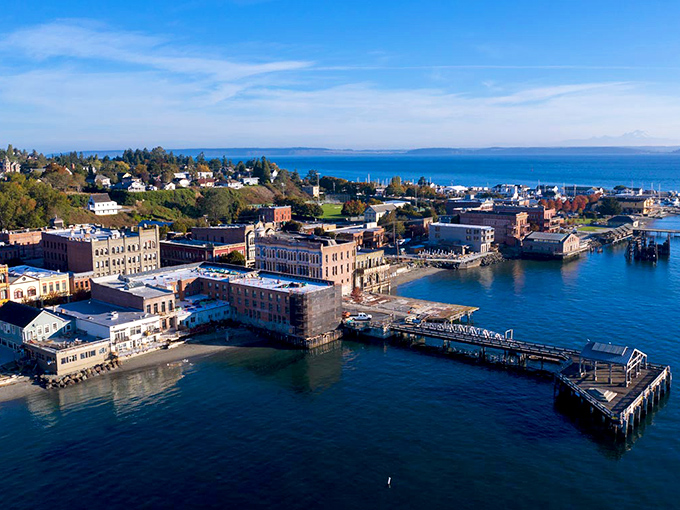 The aerial view reveals Port Townsend's perfect positioning&mdash;historic brick buildings embracing the waterfront while the residential hillside watches over everything like proud parents.