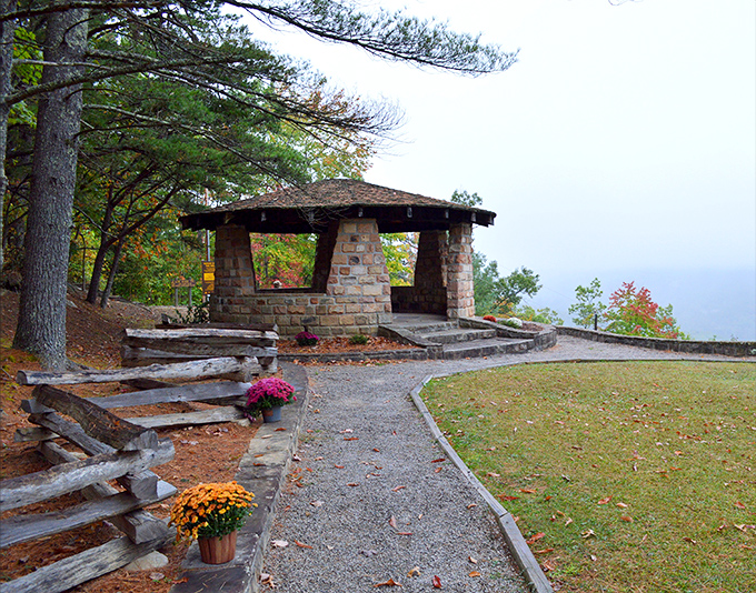 One of Kingdom Come's charming CCC-built stone shelters, where even foggy days feel magical. Those mums add a pop of color that says "autumn in Appalachia" better than words ever could.