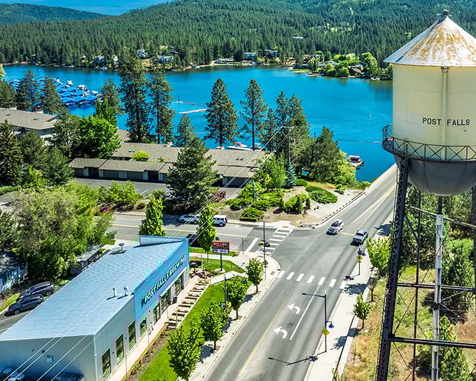 Post Falls' iconic water tower stands sentinel over turquoise waters and tree-lined shores &ndash; small-town charm with big-time views that never get old.