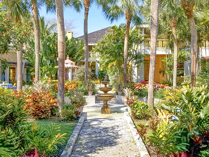 A stone pathway flanked by tropical splendor leads to the buttery-yellow main house&mdash;Florida's version of the yellow brick road to paradise.