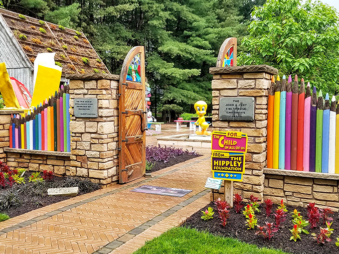 The entrance to Hippley Gardens feels like stepping through a portal to childhood wonder, complete with colorful pencil fence and a Tweety Bird greeter.