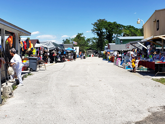 Inside OBT Flea Market, where treasure hunting becomes an Olympic sport. Colorful flags hang above endless rows of cardboard boxes filled with potential discoveries.