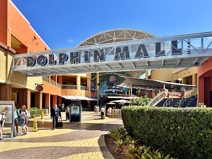 The grand entrance to Dolphin Mall welcomes shoppers with its distinctive architecture and warm Miami colors&mdash;retail therapy's pearly gates.