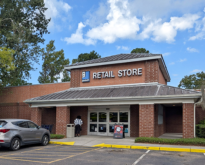 The unassuming brick exterior of Palmetto Goodwill hides a treasure trove within, like finding a secret passage to bargain paradise.
