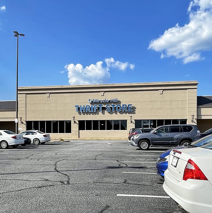 The blue sign beckons like a siren call to bargain hunters. Miracle Hill Thrift Store's bold lettering promises treasures waiting to be discovered inside.