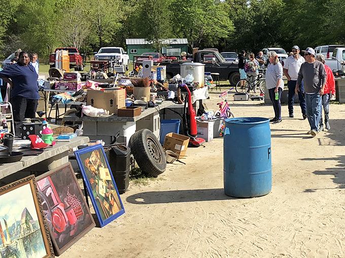 Early birds browse the bustling aisles at Florence Flea Market, where framed artwork and everyday treasures await their next home.