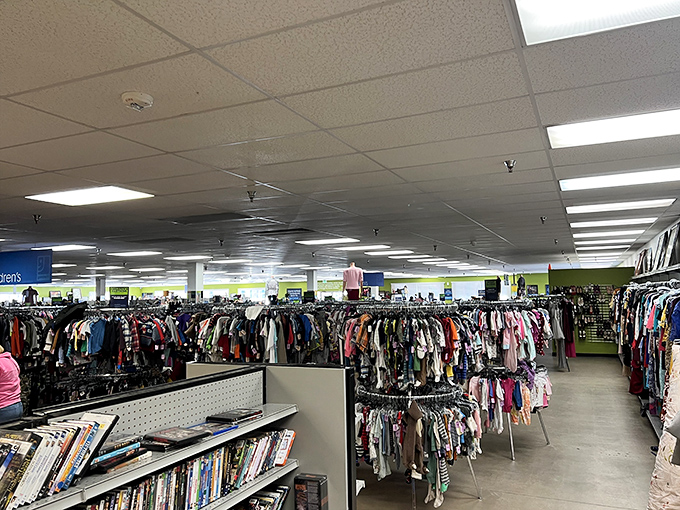 The treasure hunt begins! Row after row of clothing racks stretch into the distance, while books and media wait patiently in the foreground for their next adventure.