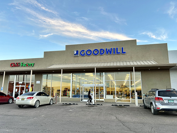 The blue Goodwill sign beckons like a lighthouse for bargain hunters navigating the sea of retail along historic Route 66 in Gallup.