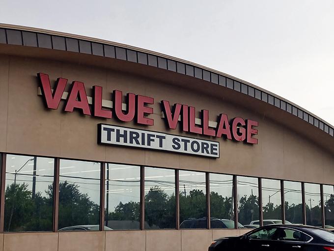 The curved facade of Value Village stands like a retail ark, ready to rescue shoppers from the flood of full retail prices.