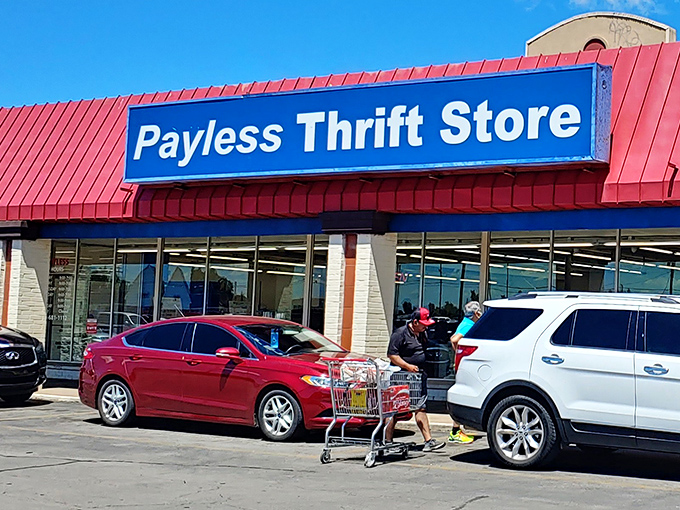 The iconic blue sign of Payless Thrift Store beckons bargain hunters like a retail lighthouse guiding ships to treasure-filled shores.