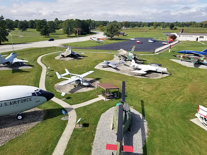 From above, this aerial wonderland looks like a military aircraft petting zoo where retired warbirds enjoy their golden years on perfectly manicured Indiana grass.