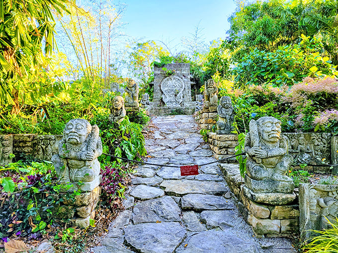 Step into a hidden world at Naples Botanical Garden&rsquo;s Kapnick Caribbean Garden, where ancient stone figures guard a path through lush tropical greenery.