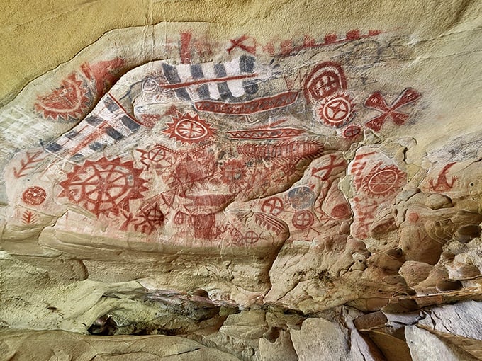 The entrance beckons like a prehistoric invitation, metal grate protecting centuries of indigenous artistry while still allowing visitors to peer into California's ancient past.