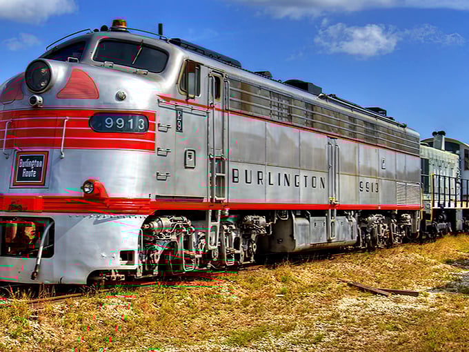 The gleaming Burlington Route diesel locomotive #9913 stands ready for its close-up, a silver and red beauty that whispers tales of America's golden age of rail travel.