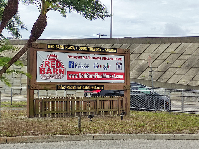 The iconic Red Barn Flea Market sign welcomes treasure hunters with promises of discoveries waiting inside, open Tuesday through Sunday for maximum bargain-hunting opportunities.