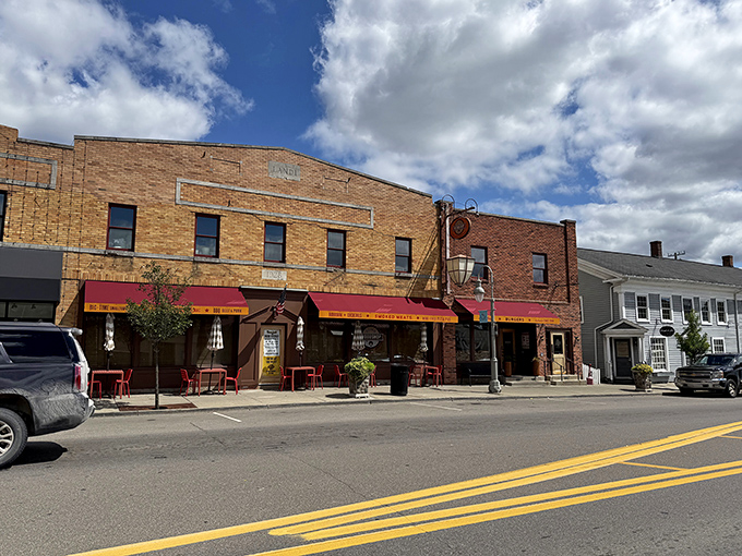 Downtown Clarkston's crown jewel stands proudly among historic buildings, its red awnings like welcome flags signaling to hungry pilgrims that barbecue salvation awaits inside.