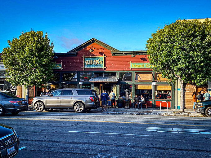 The bright red facade of Hula's Island Grill stands out against Monterey's blue sky like a tropical postcard come to life on Lighthouse Avenue.