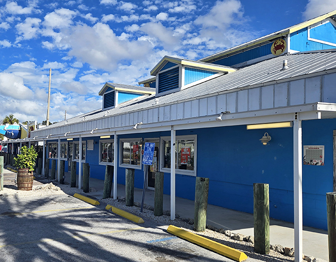 The iconic blue exterior of Crabby Bill's stands out against Florida's cloudscape like a beacon for hungry beachgoers seeking seafood salvation.