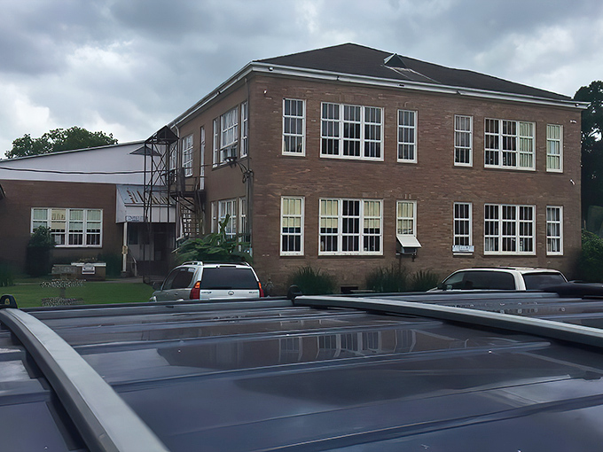 From another angle, the schoolhouse reveals its impressive scale&mdash;where generations of students once learned, treasure hunters now explore.
