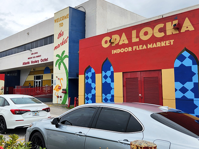 The vibrant Moorish-inspired facade of Opa Locka Indoor Flea Market welcomes bargain hunters with its distinctive blue geometric patterns and palm tree mural &ndash; Florida shopping with architectural flair!