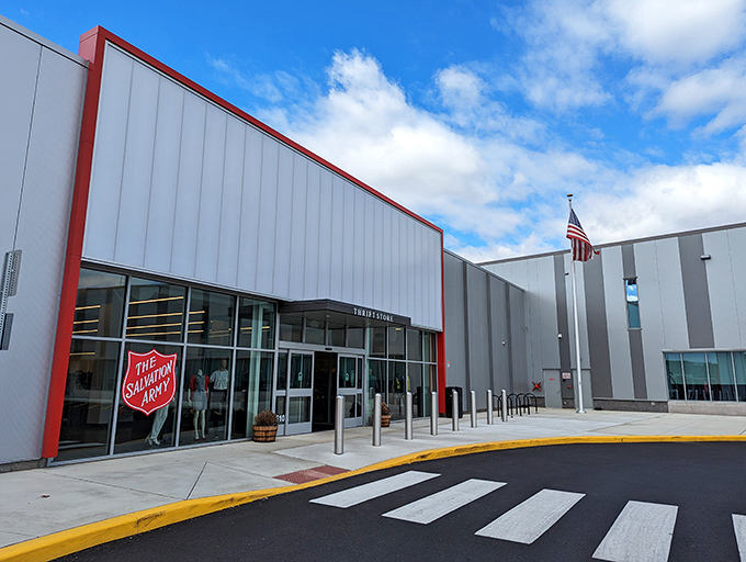 Bathed in daylight, this modern thrift emporium stands ready for bargain adventurers, complete with American flag and shopping cart corral.