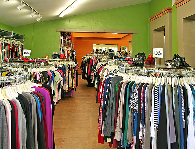 Lime green walls frame this fashion treasure hunt, where circular racks create a runway of possibilities. Your next favorite shirt is hiding somewhere between vintage and vogue.