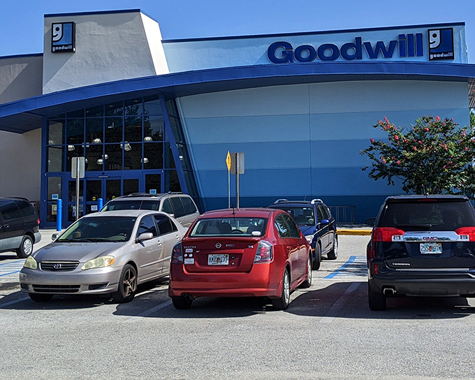 The blue-trimmed facade of Goodwill Brandon Superstore stands like a retail oasis in the Florida sun, promising air-conditioned treasure hunting inside.