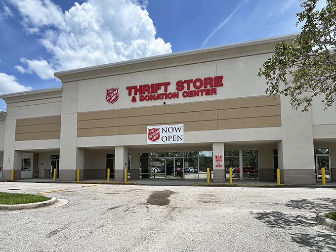 The Salvation Army Thrift Store stands proudly under Florida's blue skies, a beacon for bargain hunters with its unmistakable red signage and promise of treasures within.