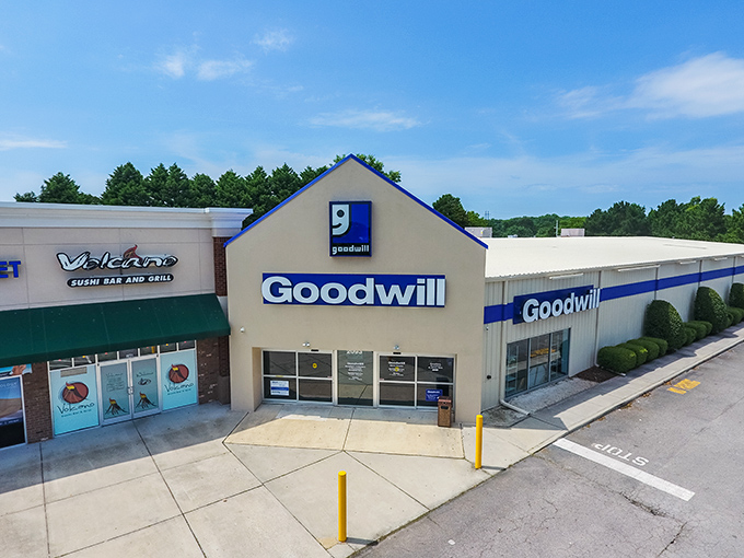 The iconic blue and white façade of Goodwill on General Booth Boulevard stands ready to welcome treasure hunters of all budgets.