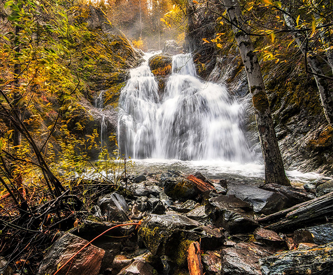 Nature's perfect cascade &ndash; Faery Falls tumbles 50 feet over moss-covered rocks, creating a crystal-clear pool that practically begs for a brave toe-dip.