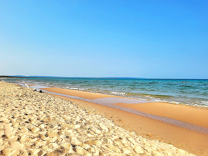 The view that makes you question why you ever bothered with Caribbean vacations. Esch Beach's pristine shoreline meets Lake Michigan's endless blue horizon.