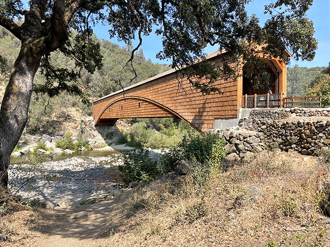 The Bridgeport Covered Bridge stands like a time capsule among the Sierra foothills, its wooden frame creating a perfect postcard moment against California's blue skies.
