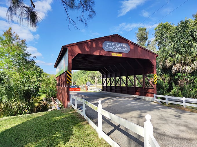 A splash of New England charm with a Florida twist! The Coral Springs Covered Bridge welcomes visitors with its classic barn-red exterior and tropical palm backdrop.