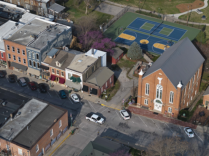 Weston's aerial view reveals its perfect small-town layout &ndash; complete with historic brick buildings, a stately church, and those tennis courts where I'd surely embarrass myself spectacularly.