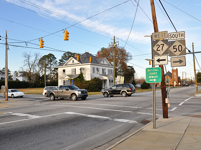 Classic American architecture meets Southern hospitality at this intersection. That white Victorian house isn't just photogenic&mdash;it's a testament to Benson's commitment to preserving its historical character.